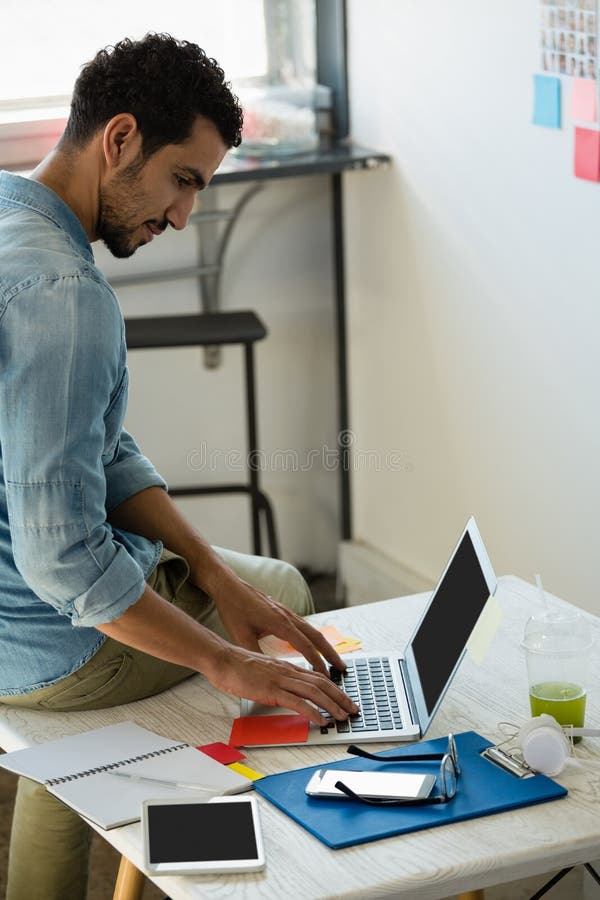 Man using laptop in office stock photo. Image of corporate - 95671222