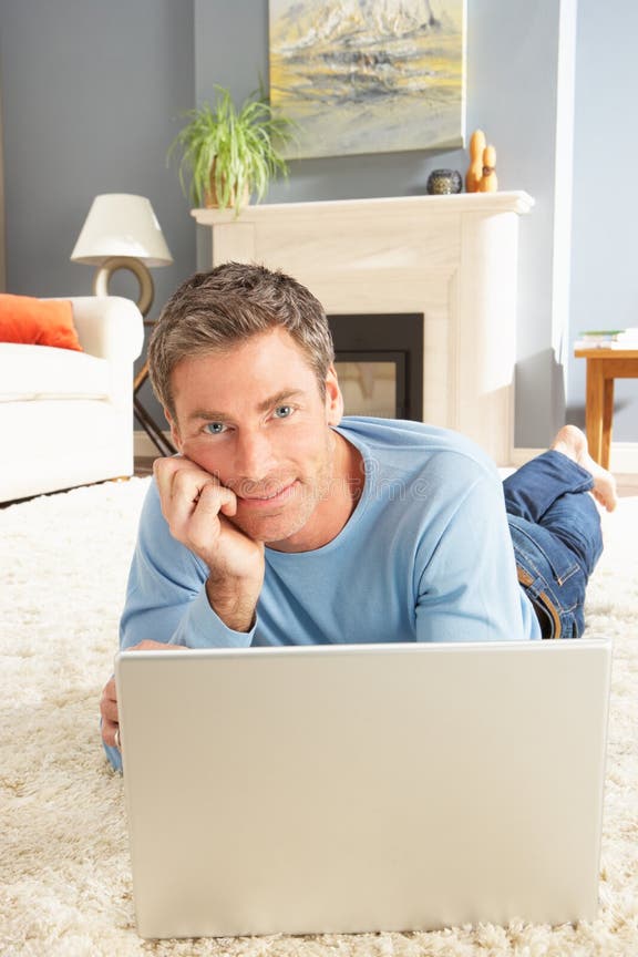 Man Using Laptop Relaxing Laying on Rug at Home Stock Image - Image of ...