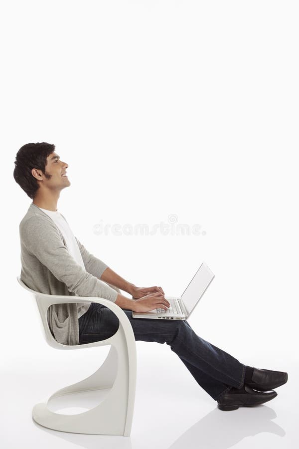 Man Using Laptop while Sitting on a Chair Stock Image - Image of color ...
