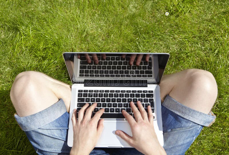 Man Using Laptop Sitting on Grass Stock Photo - Image of ethnicity ...