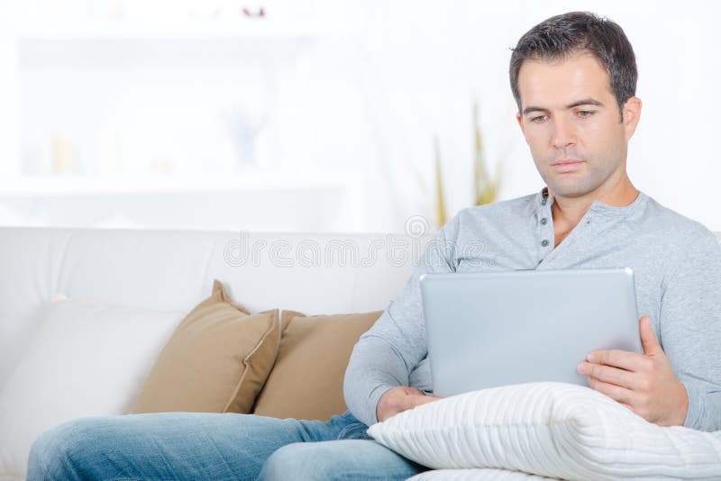 Man Using Laptop while Sitting at Home on Sofa Stock Image - Image of ...