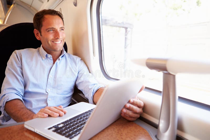 Man Using Laptop on Train stock image. Image of male - 33577581