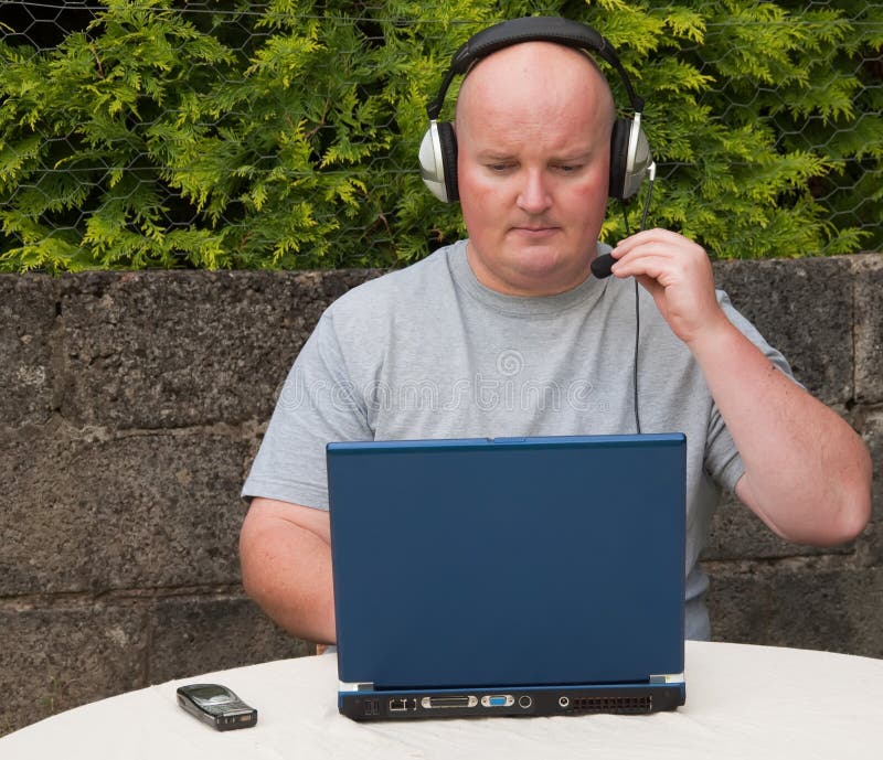 Man using laptop and voip stock photo. Image of computer - 10427574