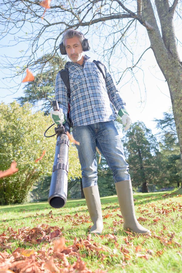 Man using leaf blower stock photo. Image of green, turf - 117256876