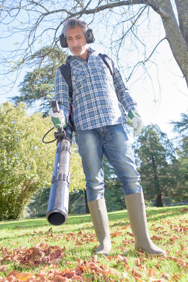 Man using leaf blower stock image. Image of noisy, aged - 118896693