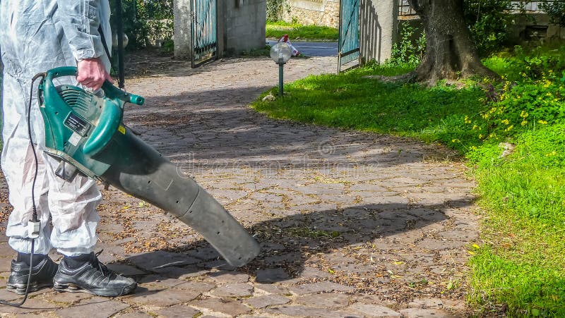 Man using a leaf blower stock image. Image of blower - 150004669