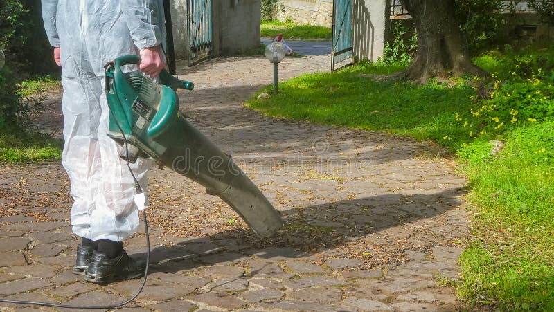Man using a leaf blower stock image. Image of nature - 150004809