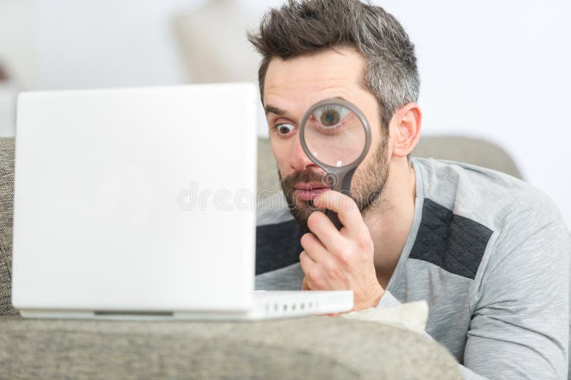 Man Using Magnifying Glass on Laptop Stock Photo - Image of magnifying ...