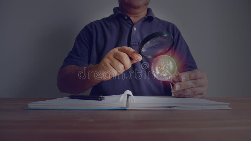 Man Using Magnifying Glass Looking Shining Light Bulb , Idea Concept ...