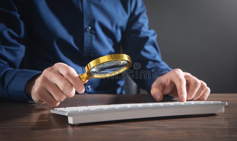 Man Using Magnifying Glass and Typing in Computer Keyboard. Concept of ...