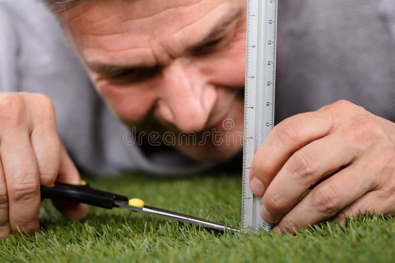 Man Using Measuring Scale while Cutting Grass Stock Photo - Image of ...