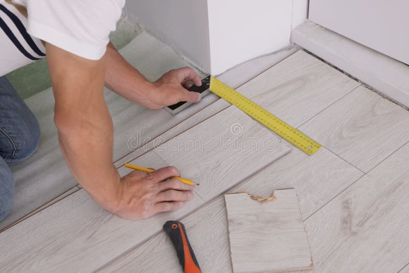 Man Using Measuring Tape during Installation of Laminate Flooring ...