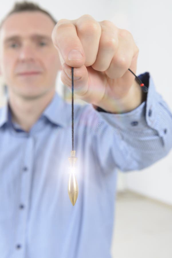 Man using metal pendulum stock image. Image of dowser - 188844783