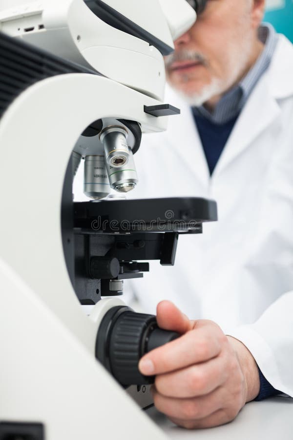Man Using a Microscope in a Laboratory Stock Photo - Image of ...