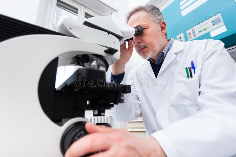 Man Using a Microscope in a Laboratory Stock Image - Image of chemistry ...