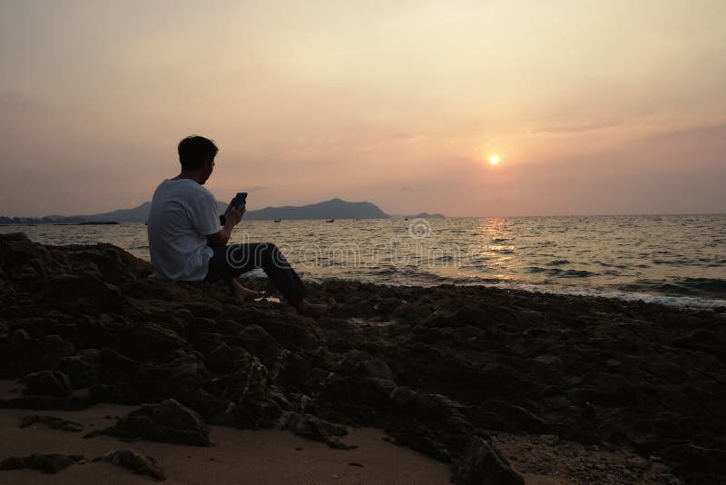 A Man Using Mobile Phone on the Beach Stock Photo - Image of phone ...