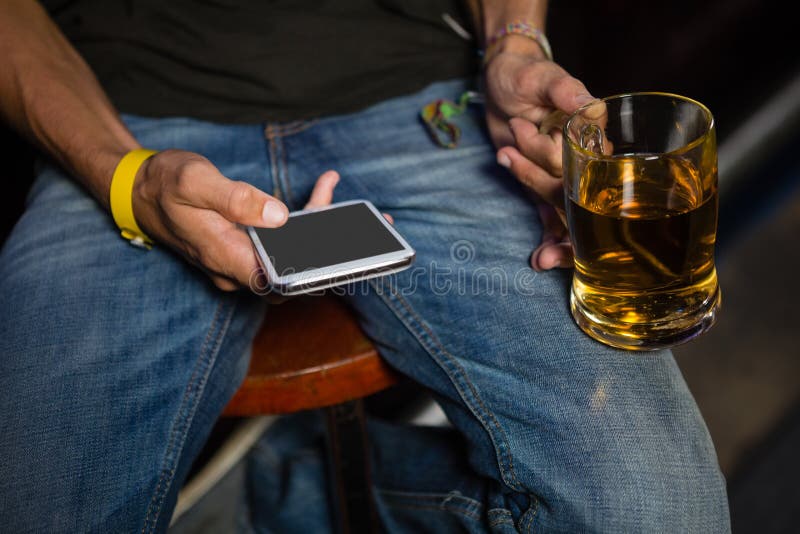 Man Using Mobile Phone while Having Beer in Bar Stock Photo - Image of ...