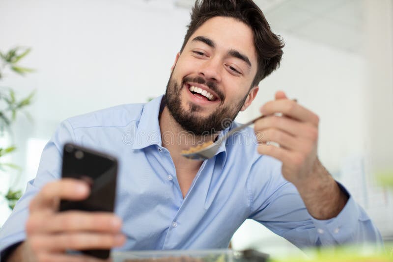 Man Using Mobile Phone while Having Lunch in Restaurant Stock Photo ...