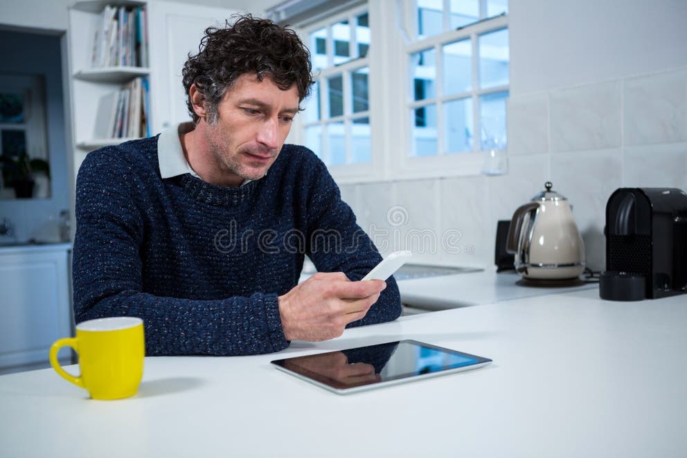 Man Using Mobile Phone in the Kitchen Stock Image - Image of message ...