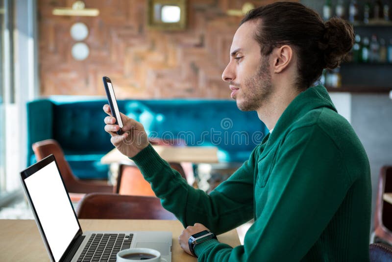 Man Using Mobile Phone with Laptop on Table Stock Image - Image of ...