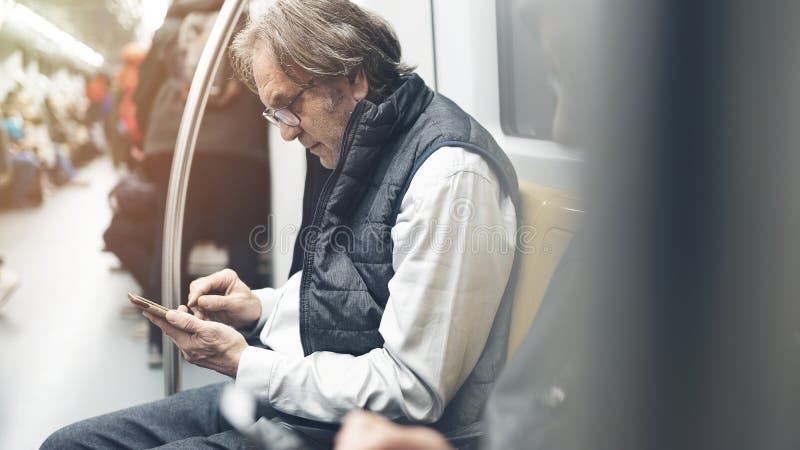 Man Using Mobile Phone in the Metro Train Stock Image - Image of news ...