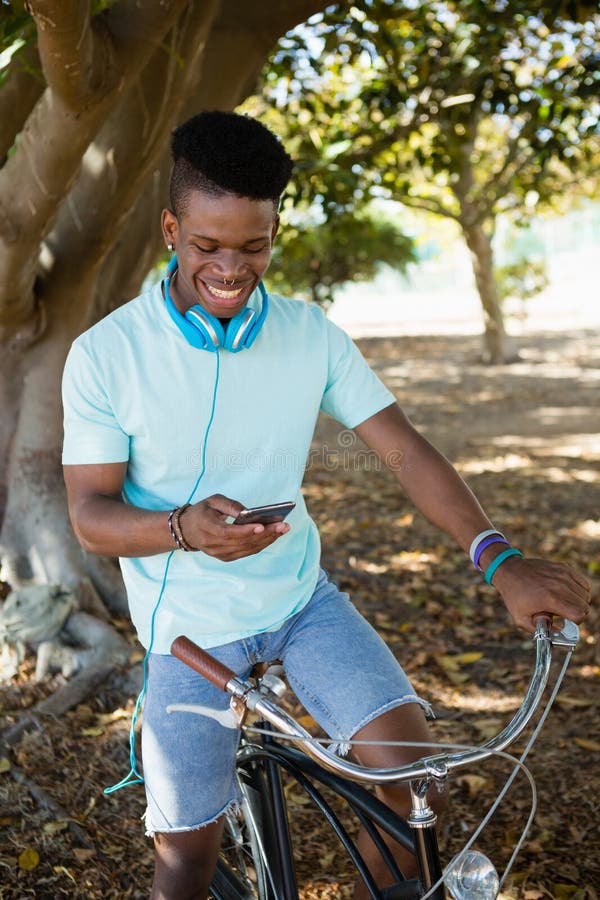 Man Using Mobile Phone while Riding His Bicycle Stock Image - Image of ...