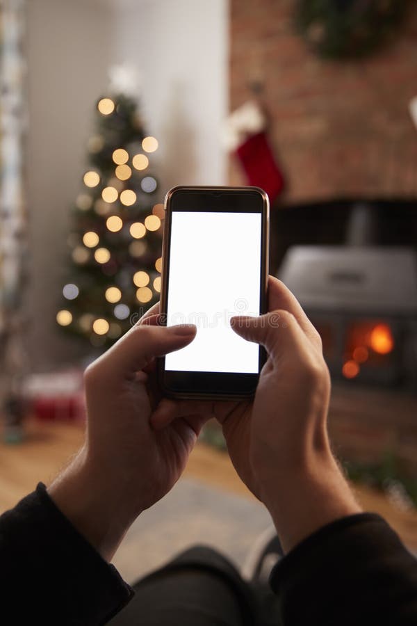 Man Using Mobile Phone in Room Decorated for Christmas Stock Image ...