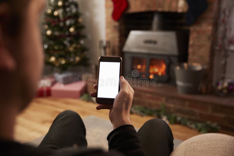 Man Using Mobile Phone in Room Decorated for Christmas Stock Photo ...