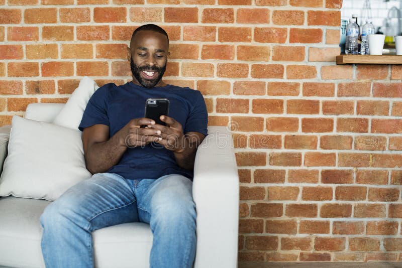 Man Using Mobile Phone Sitting on Couch Stock Photo - Image of chatting ...
