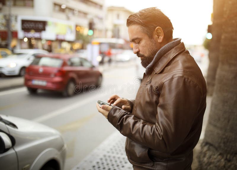 Man Using Mobile Phone at Street Stock Photo - Image of male, phone ...