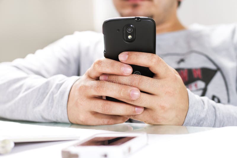 Man Using Mobile Phone while Working on Desktop Stock Photo - Image of ...