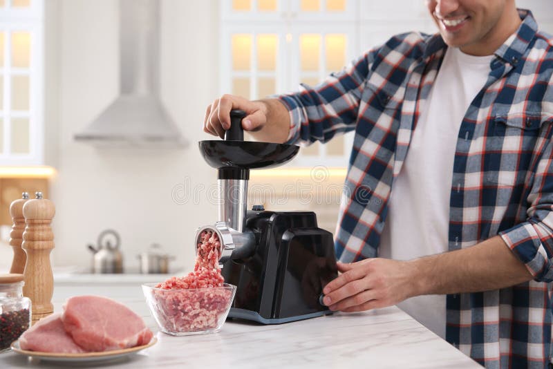 Man Using Modern Meat Grinder in Kitchen, Closeup Stock Image - Image ...