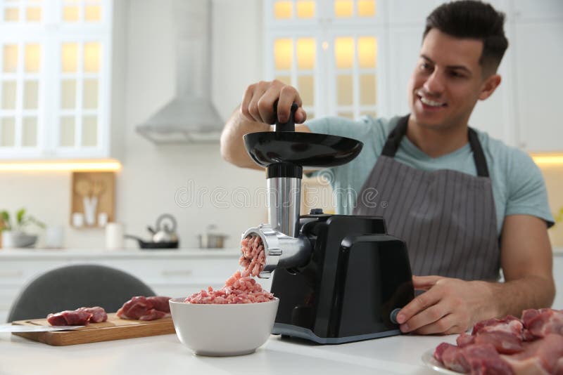 Man Using Modern Meat Grinder in Kitchen Stock Photo - Image of dinner ...