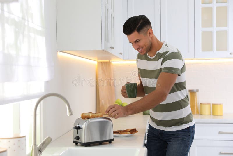 Man Using Modern Toaster at Kitchen Counter Stock Image - Image of ...