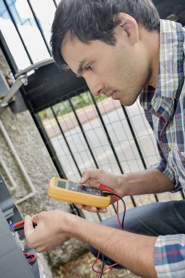 Man Using Multimeter on Exterior Electrical Box Stock Image - Image of ...