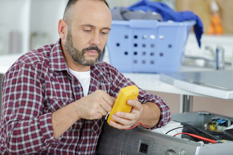 Man Using Multimeter To Find Washing Machine Fault Stock Photo - Image ...