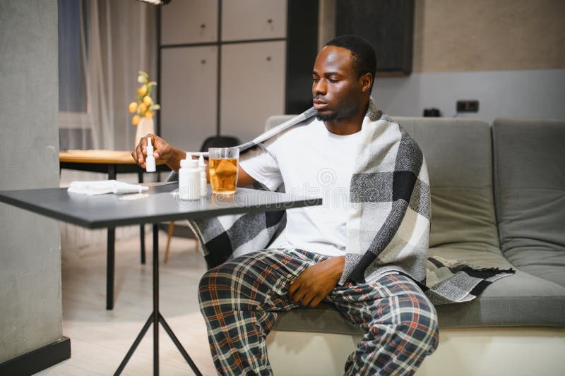 Man Using Nasal Spray for Relief from Allergies or Cold, Sitting in a ...