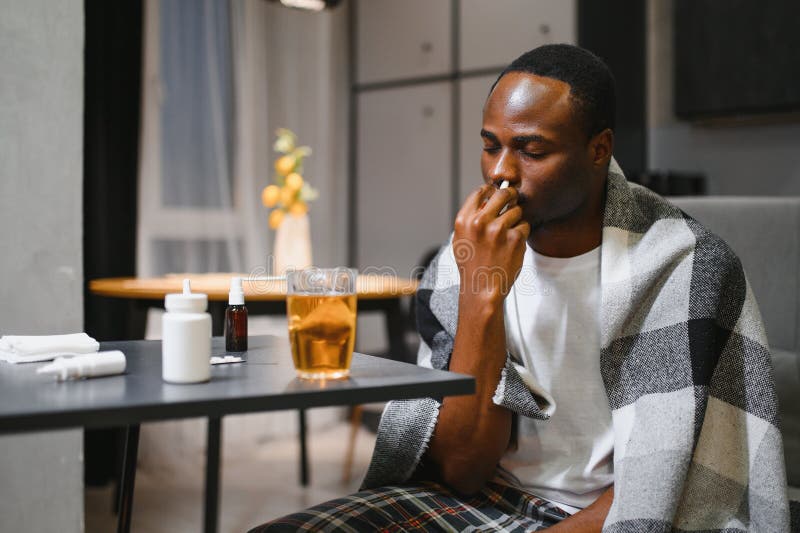 Man Using Nasal Spray for Relief from Allergies or Cold, Sitting in a ...