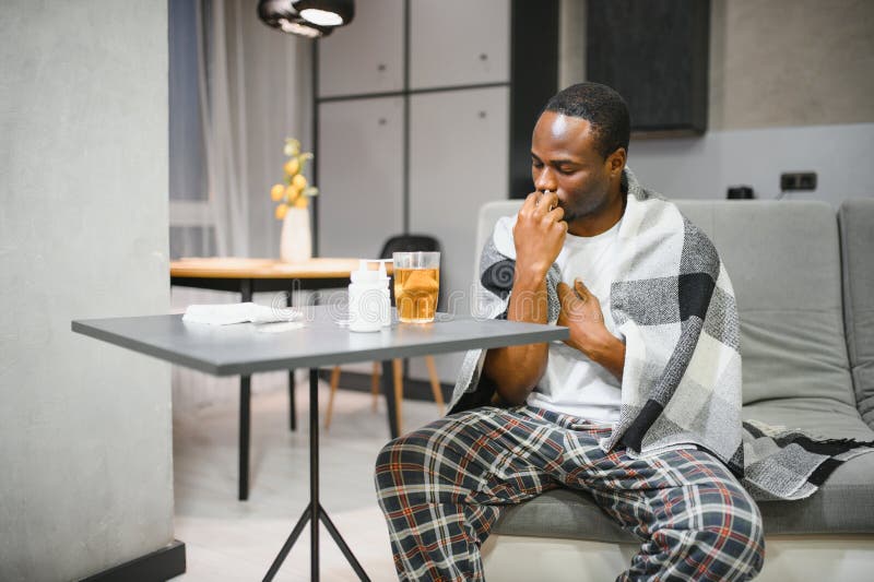 Man Using Nasal Spray for Relief from Allergies or Cold, Sitting in a ...