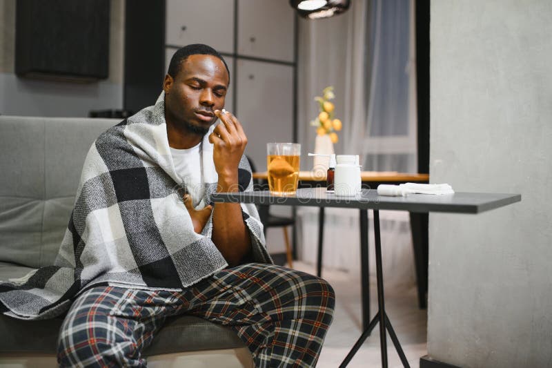 Man Using Nasal Spray for Relief from Allergies or Cold, Sitting in a ...
