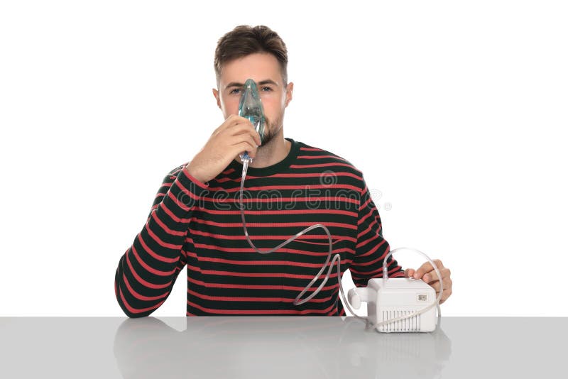 Man Using Nebulizer for Inhalation at Table on White Background Stock ...