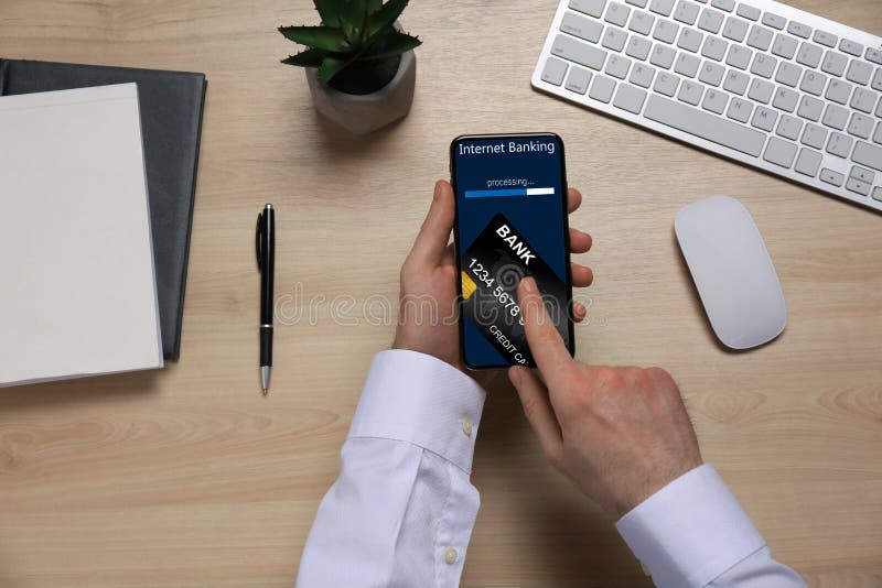 Man Using Online Banking Application on Smartphone at Wooden Table, Top ...