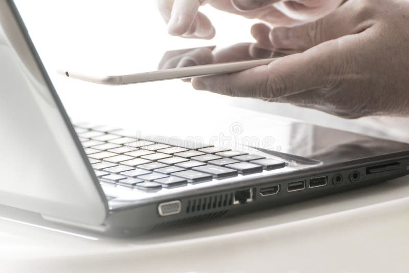Man Using an Online Banking Web App Holding a Smartphone and a Laptop ...