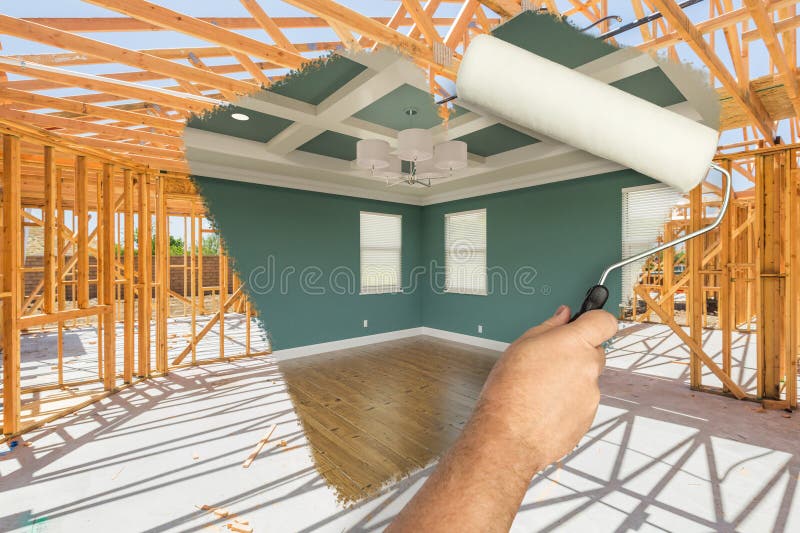 Man Using Paint Roller To Expose Finished Build of House Construction ...
