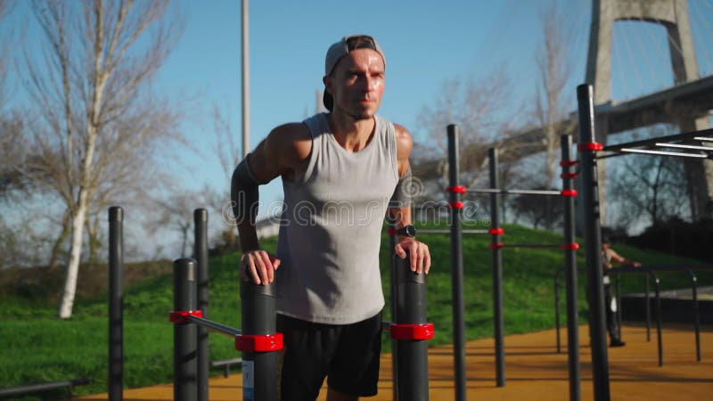 Man Doing Parallel Bar Exercises Outside Stock Footage - Video of ...