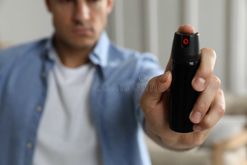Man Using Pepper Spray at Home, Focus on Hand Stock Photo - Image of ...