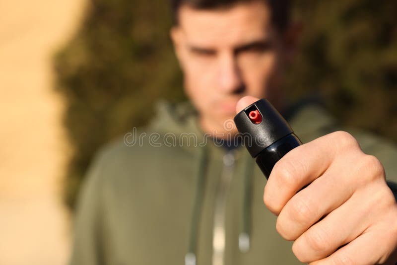 Man Using Pepper Spray Outdoors, Focus on Hand. Space for Text Stock ...