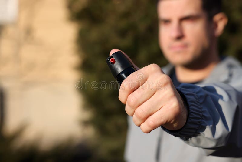 Man Using Pepper Spray Outdoors, Focus on Hand. Space for Text Stock ...
