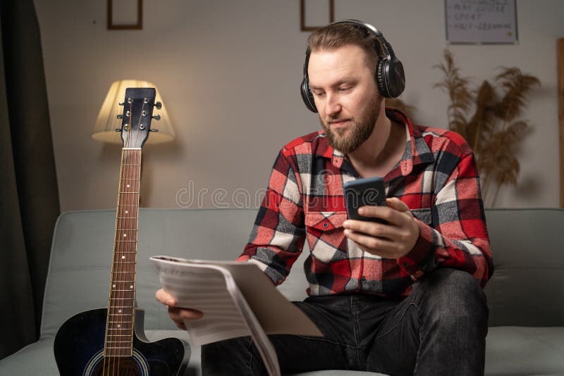 Man Using a Phone for Entertainment and Learning Notes for Playing ...