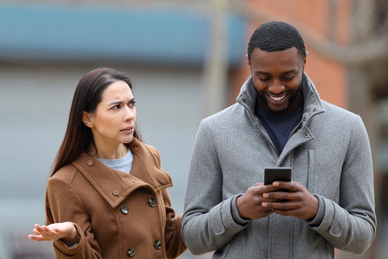 Man Using Phone Ignoring Her Friend in the Street Stock Image - Image ...
